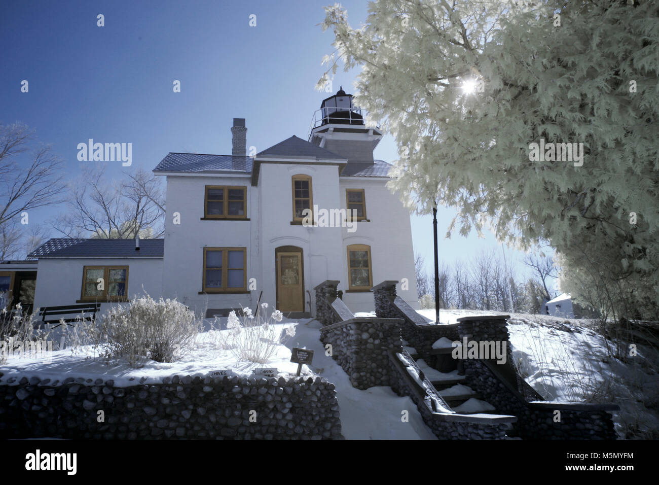 Exterior of historic Mission Point Lighthouse in winter in infrared ...