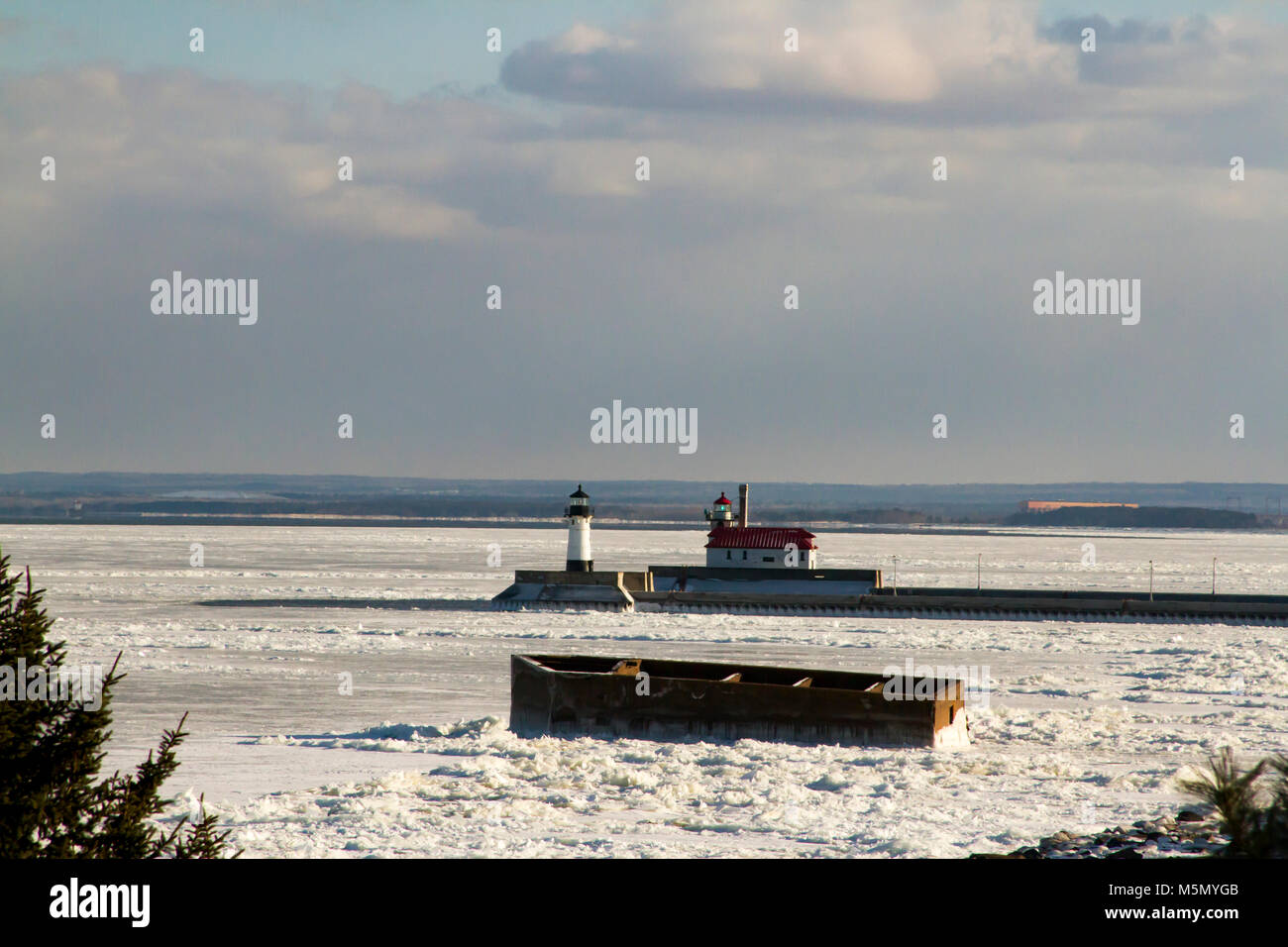 Frozen Lake Superior shoreline with The Crib, lighthouses and shipping ...