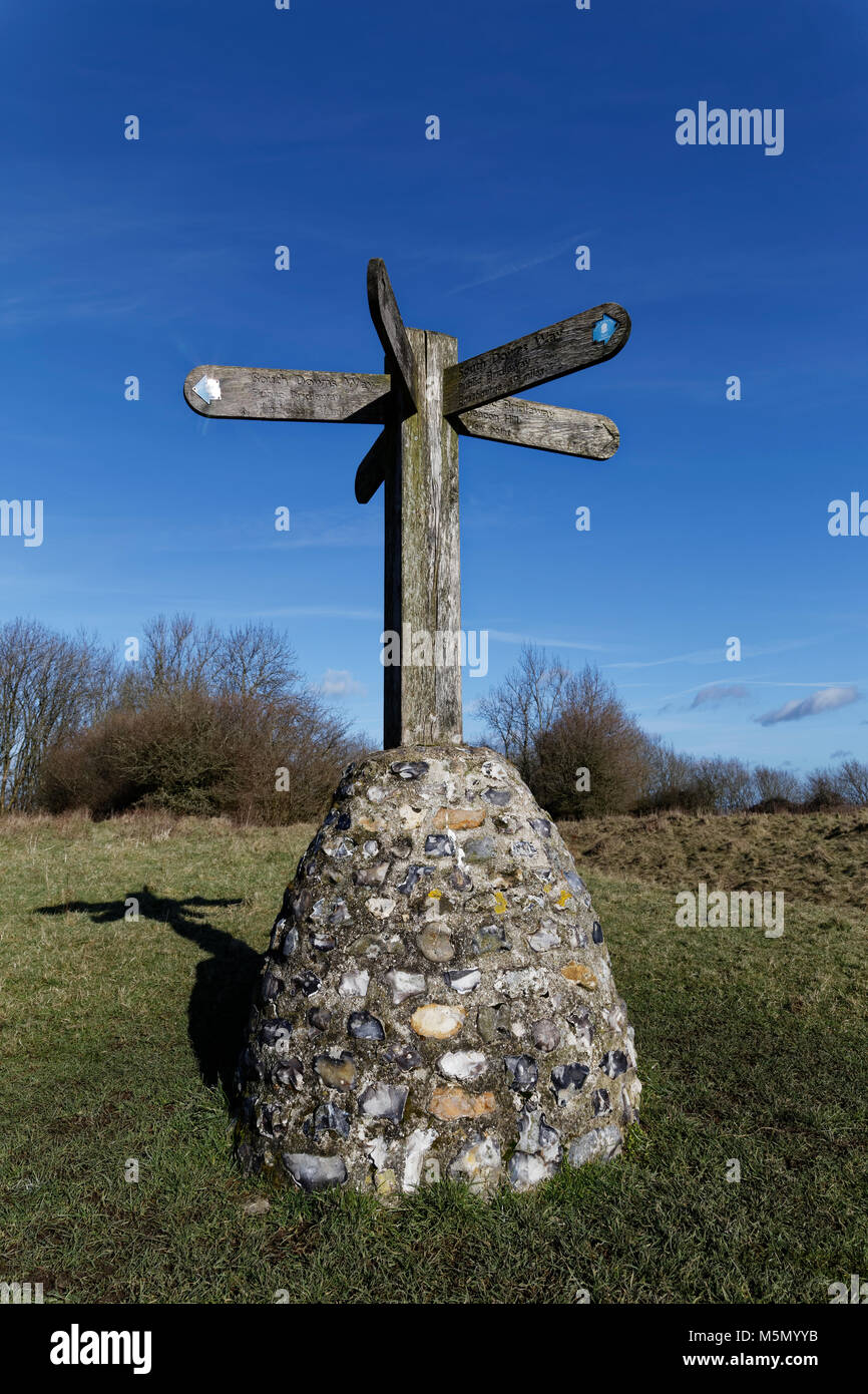 A four way signpost against a blue sky on the South Downs Way South ...