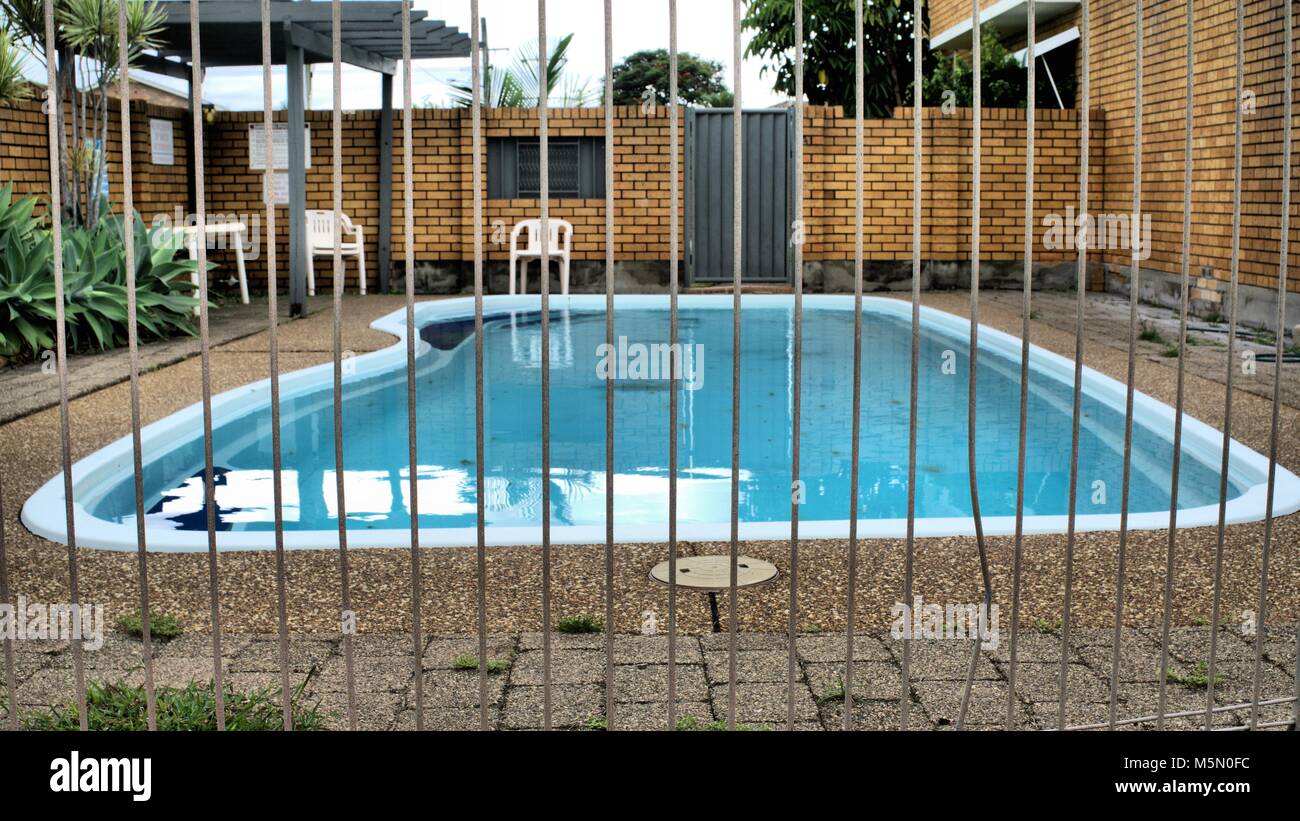 Fenced swimming pool in Australia. Swimming pool behind metal fence ...