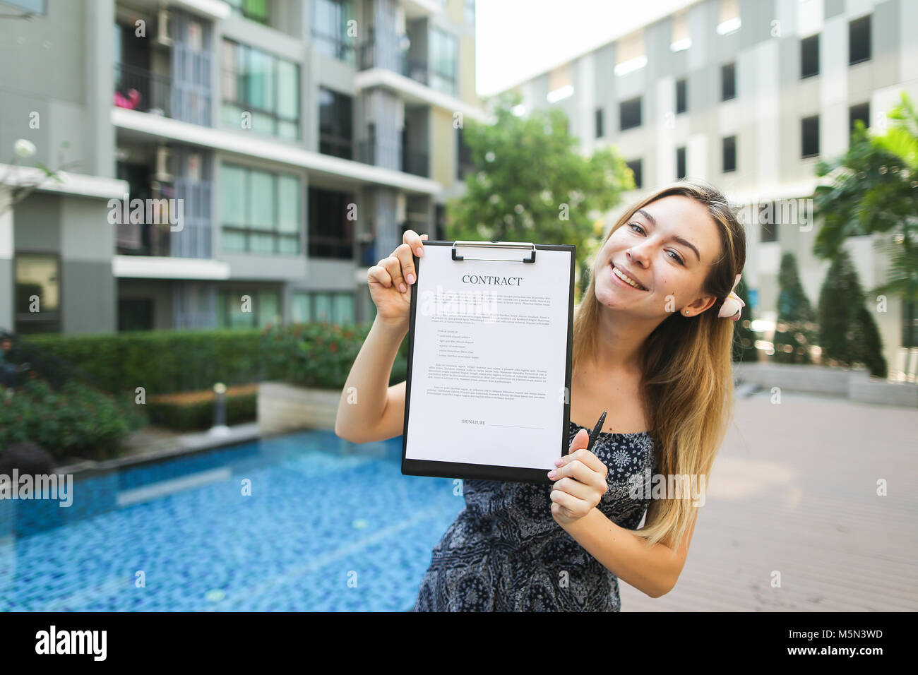 young woman offer to sign contract document on background of new Stock ...