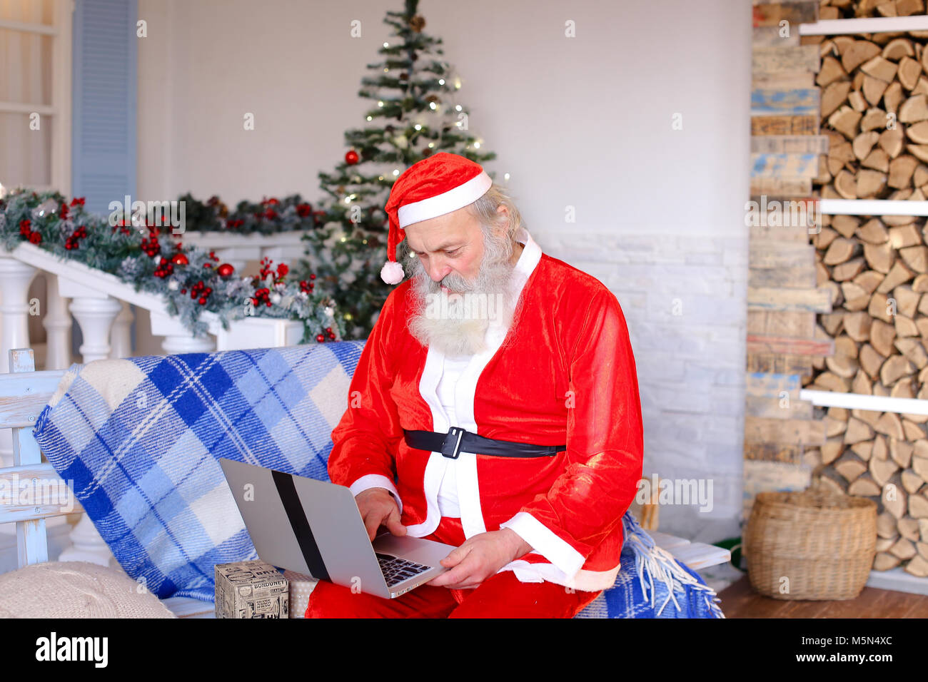 Gracious Santa Claus working on laptop Stock Photo - Alamy