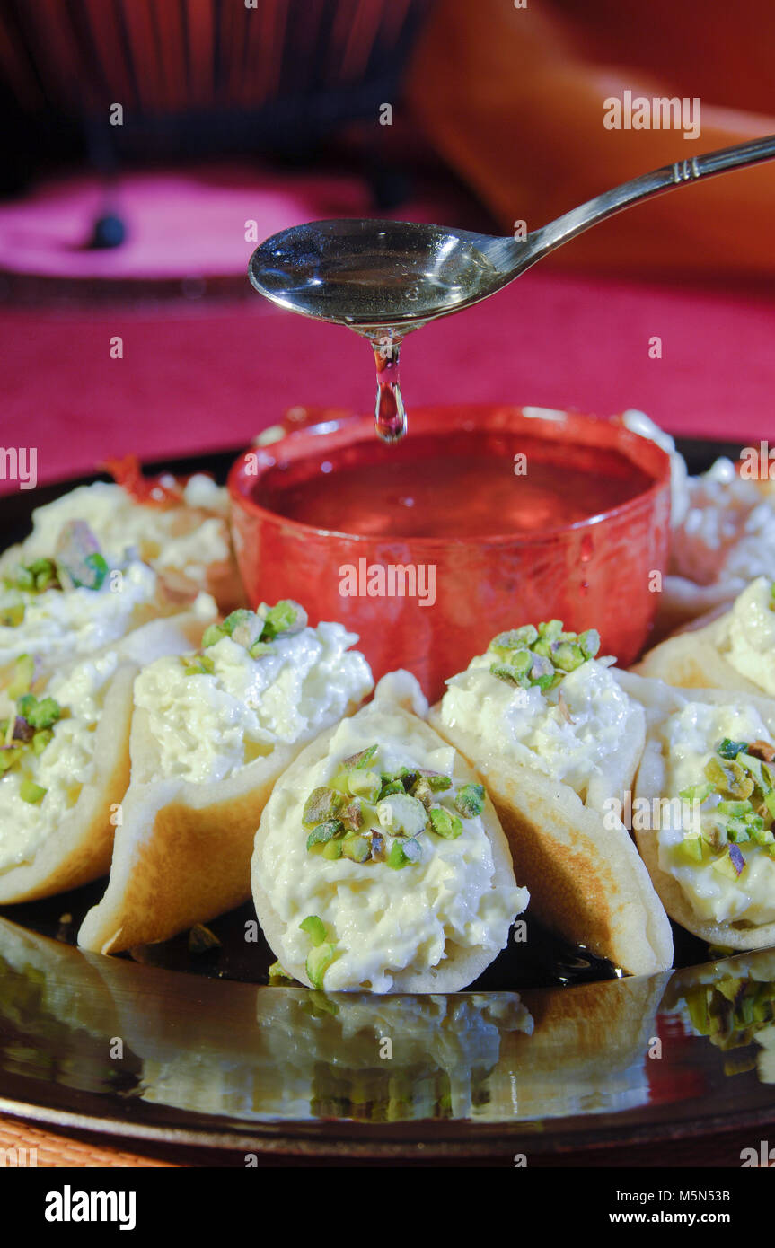 Pouring Syrup on Asafeer, Arabic Sweets with Cream for Ramadan and Eid ...