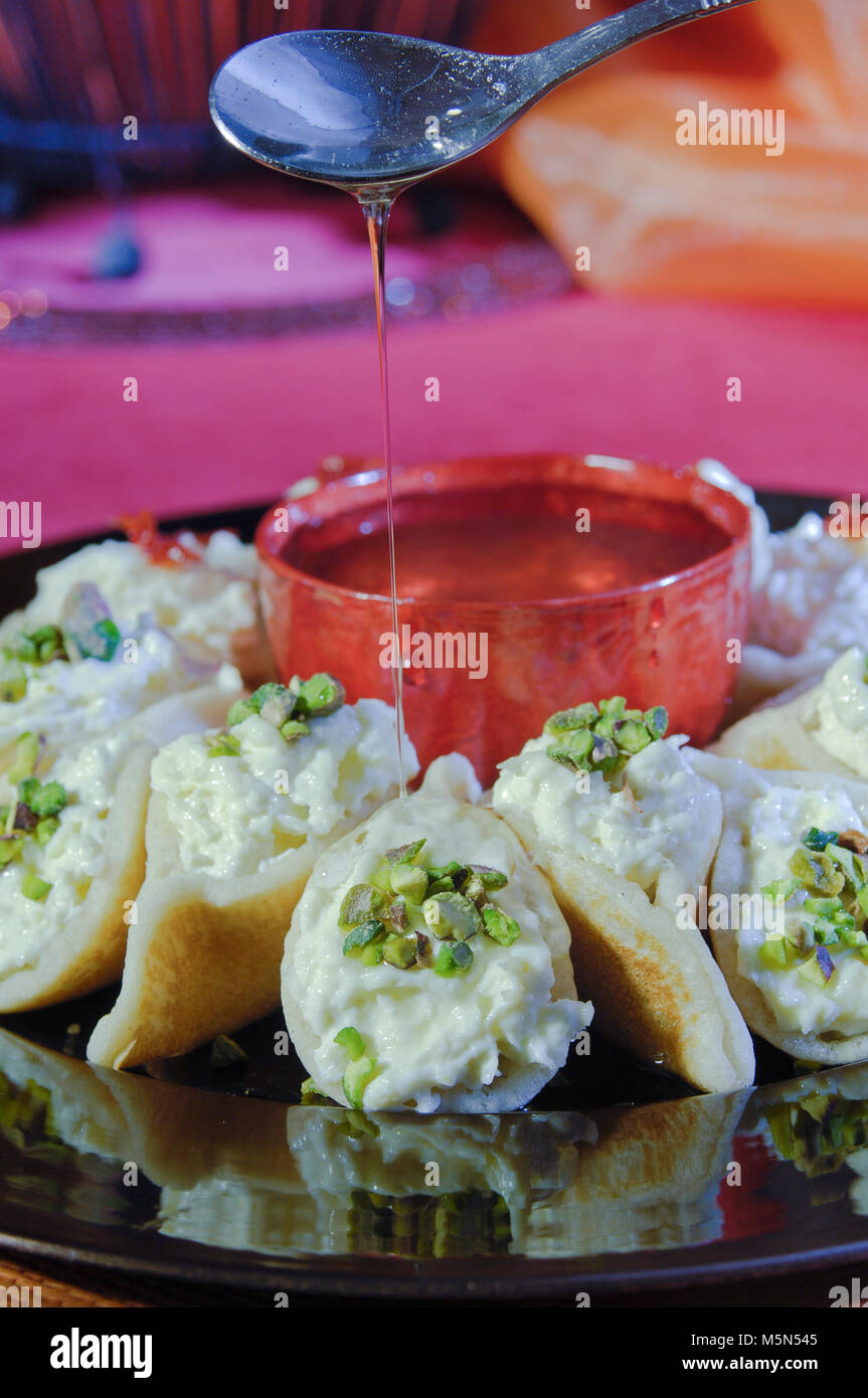 Pouring Syrup on Asafeer, Arabic Sweets with Cream for Ramadan and Eid ...