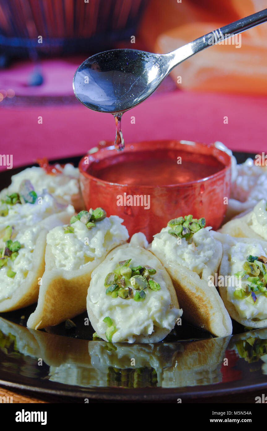 Pouring Syrup on Asafeer, Arabic Sweets with Cream for Ramadan and Eid ...