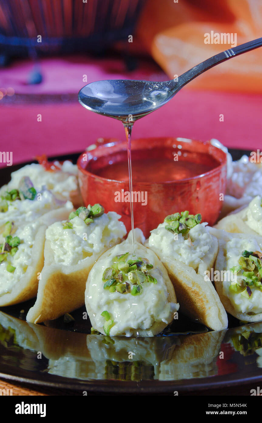 Pouring Syrup on Asafeer, Arabic Sweets with Cream for Ramadan and Eid ...
