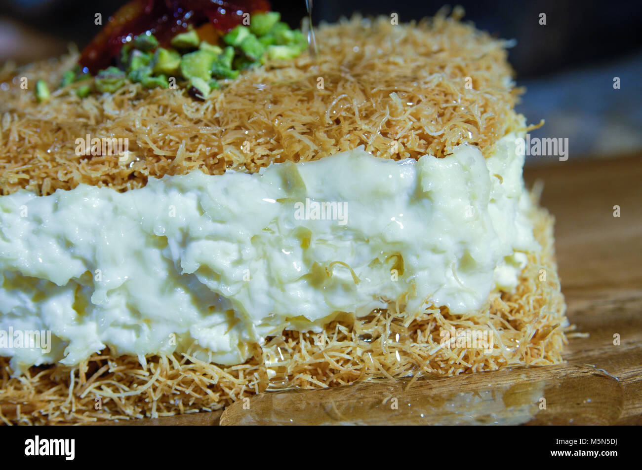 Pouring Syrup on Osmaliya, Arabic Sweets with Cream for Ramadan and Eid ...