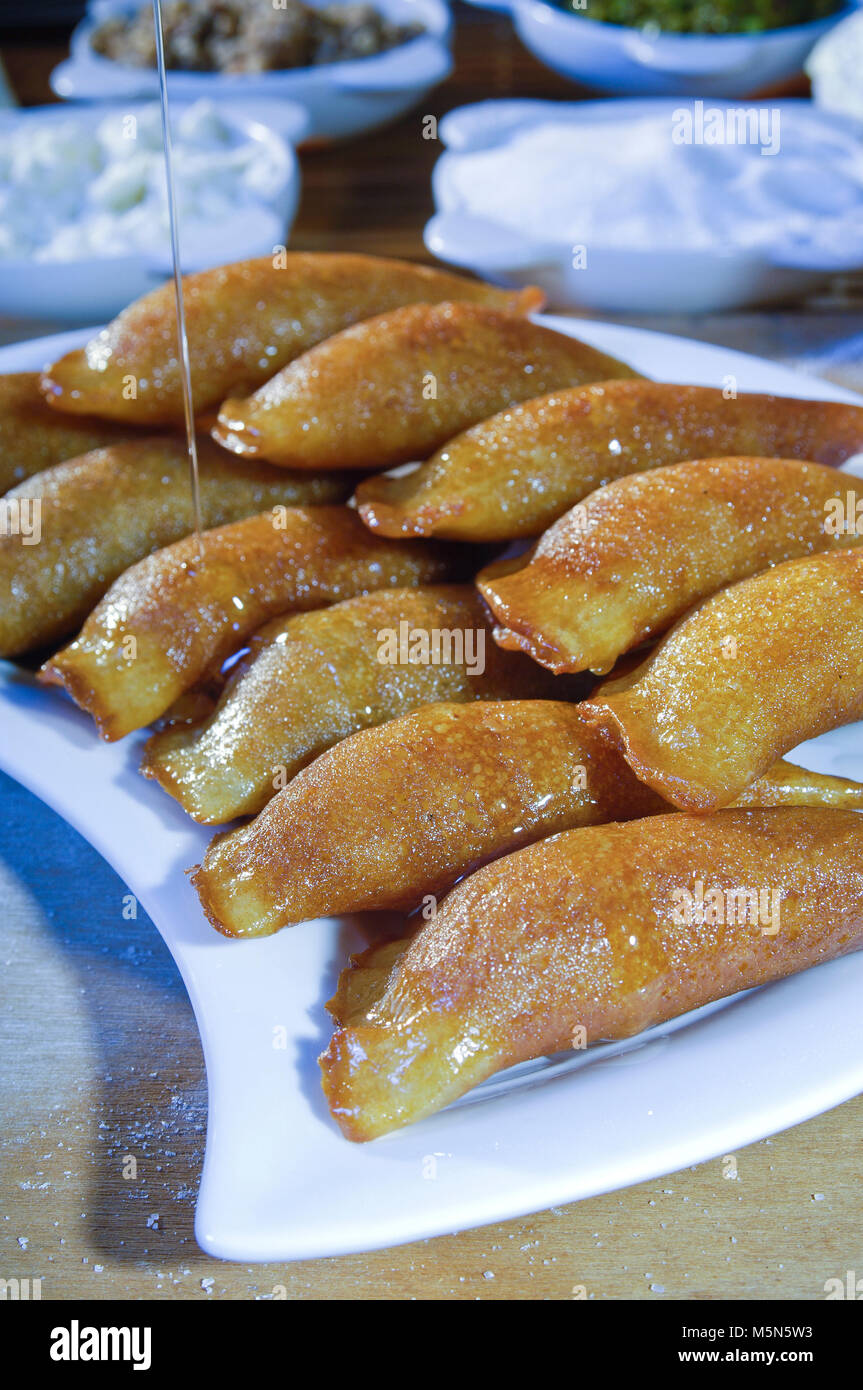 Pouring Syrup on Qatayef, Arabic Sweets with Nuts and Other Ingredients ...