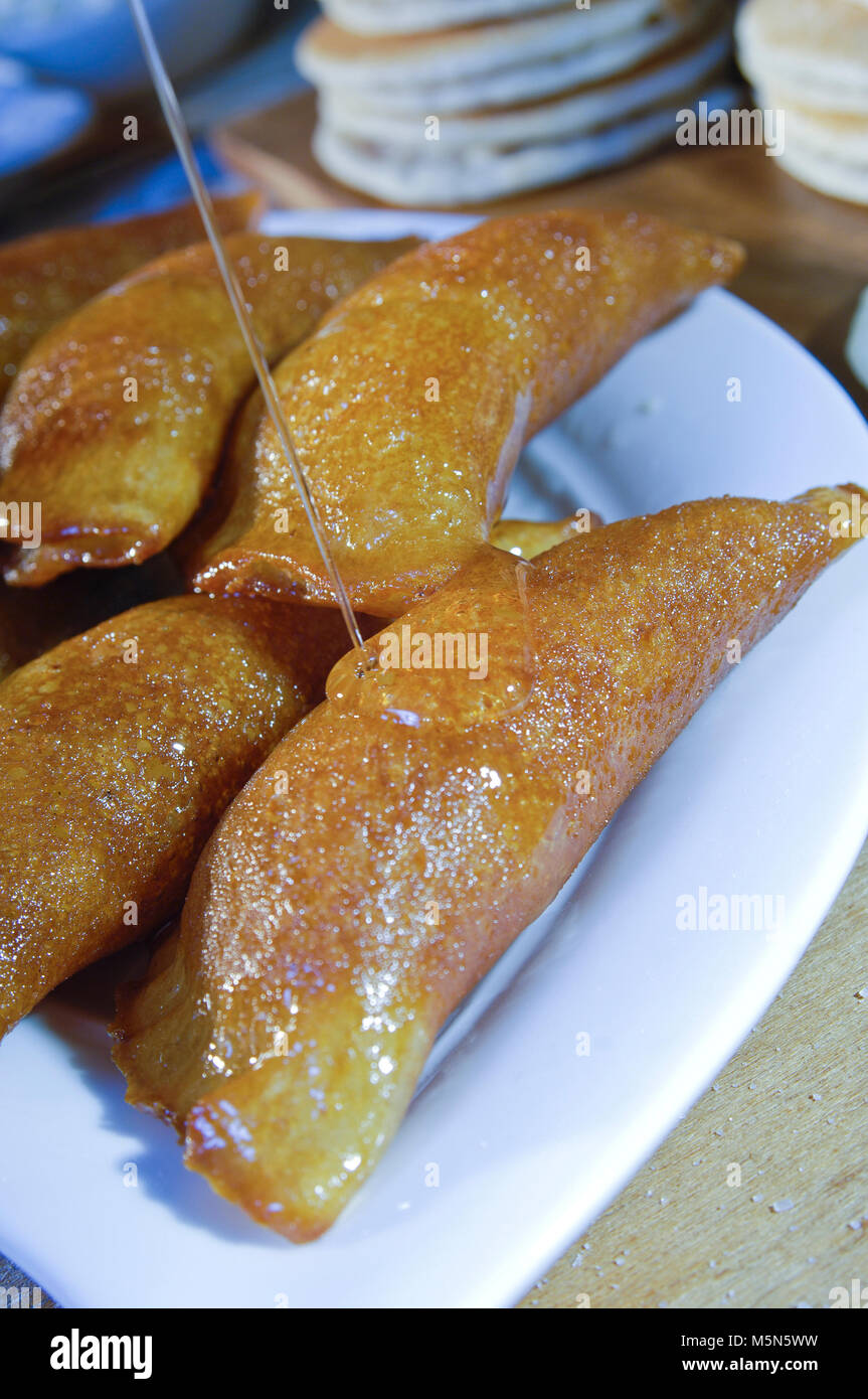 Pouring Syrup on Qatayef, Arabic Sweets with Nuts and Other Ingredients ...