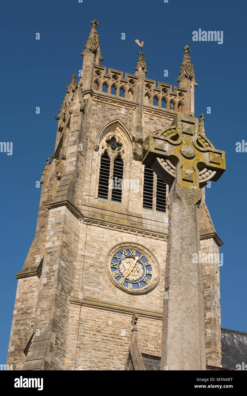 a church steeple or tower with a celtic cross sybol and sculpture in ...