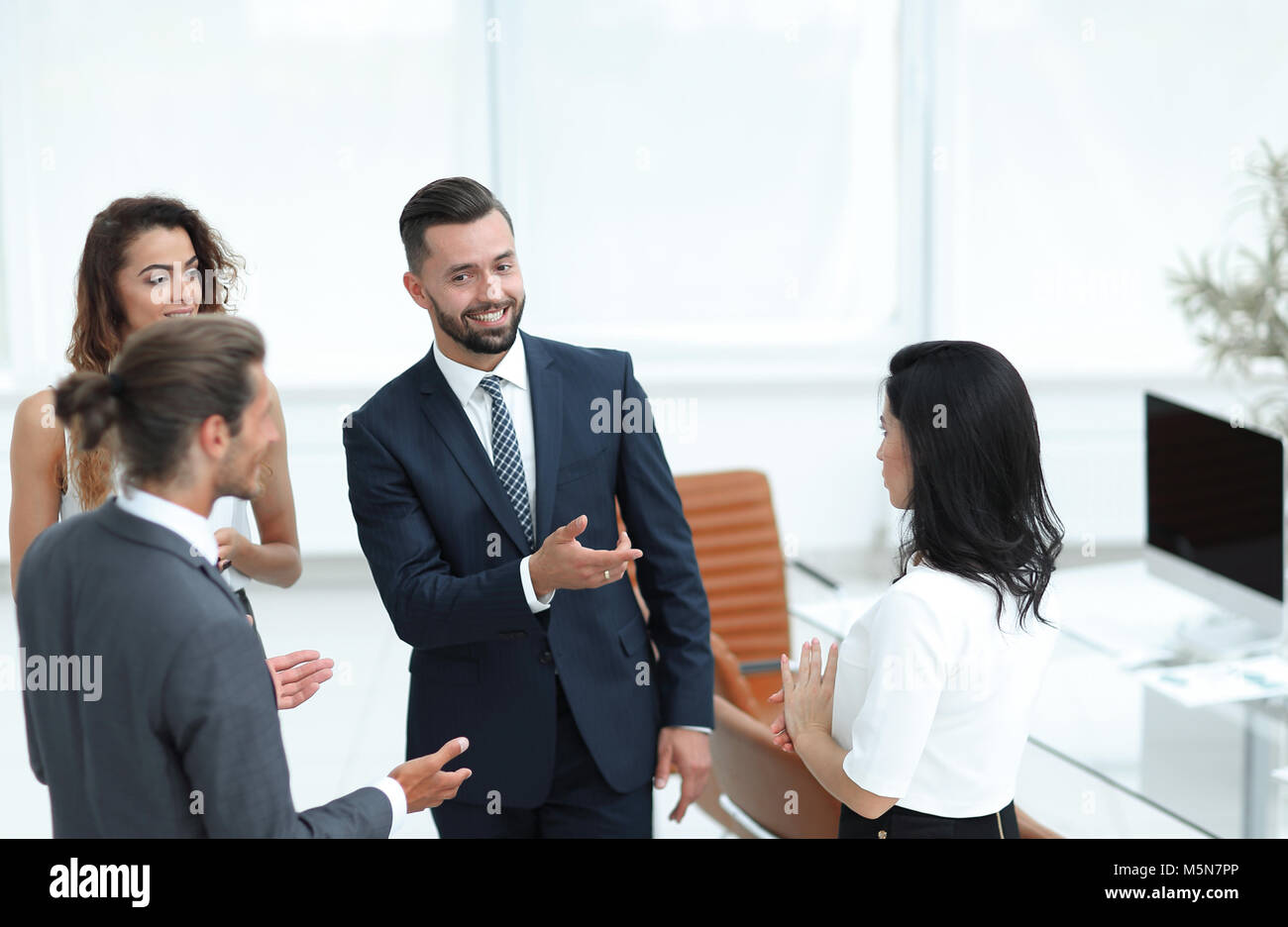 business team talking, standing in office Stock Photo - Alamy