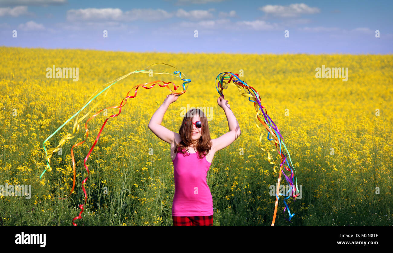 happy little girl playing with colorful ribbons spring season Stock ...