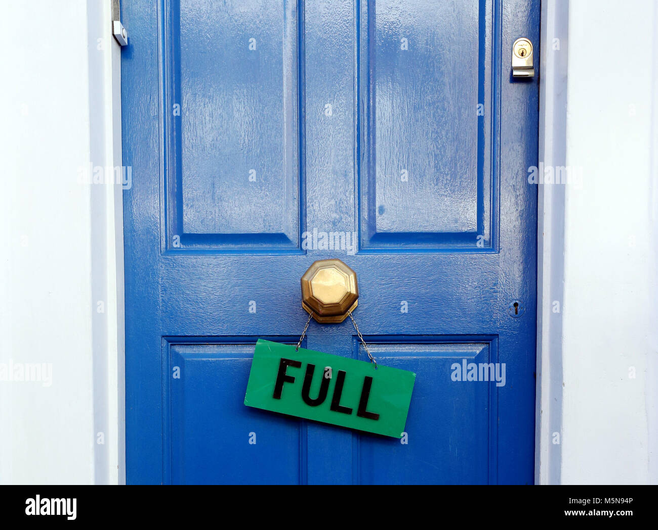A full occupancy sign hangs upon the door to the Chester Hotel ...