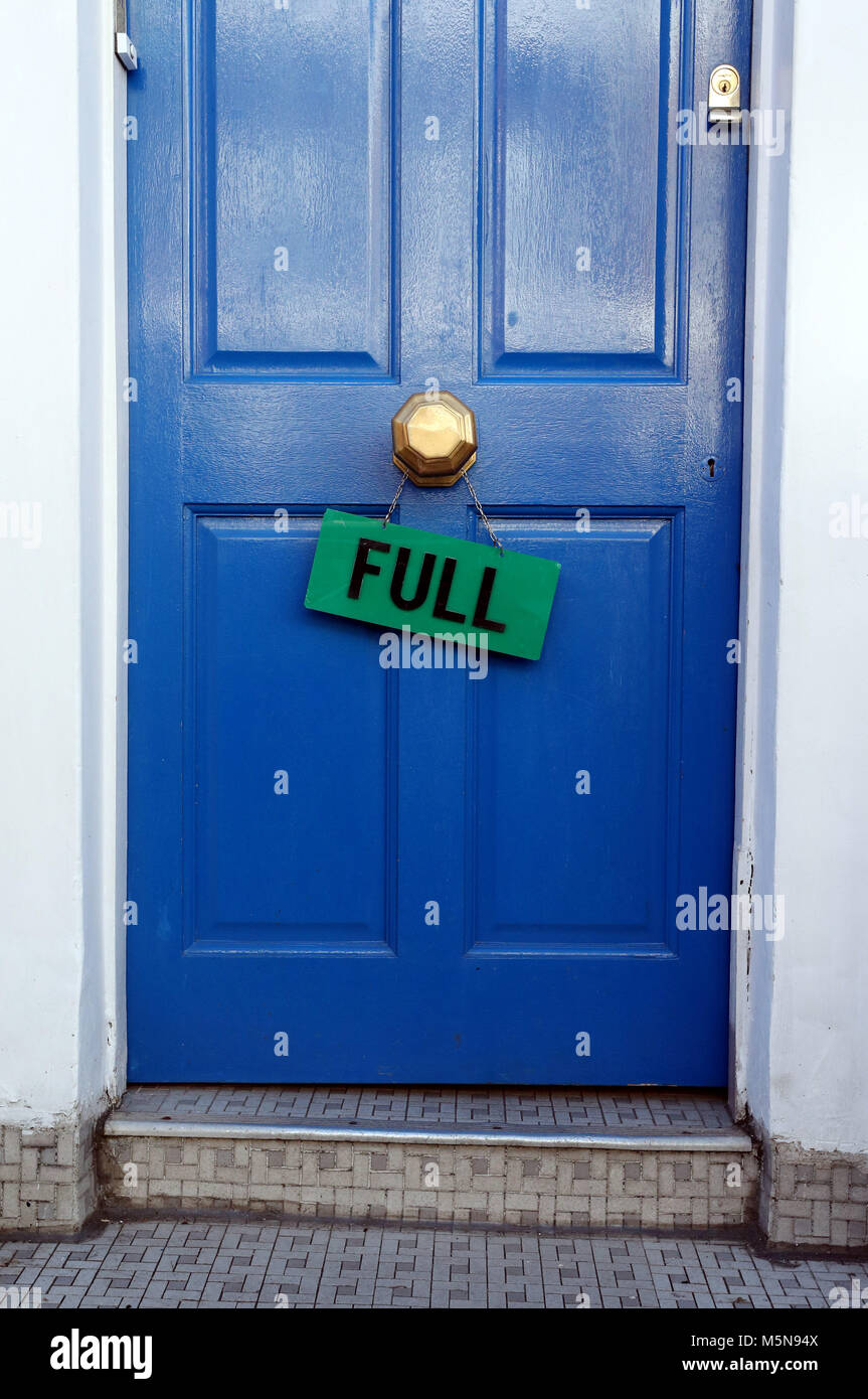A full occupancy sign hangs upon the door to the Chester Hotel ...