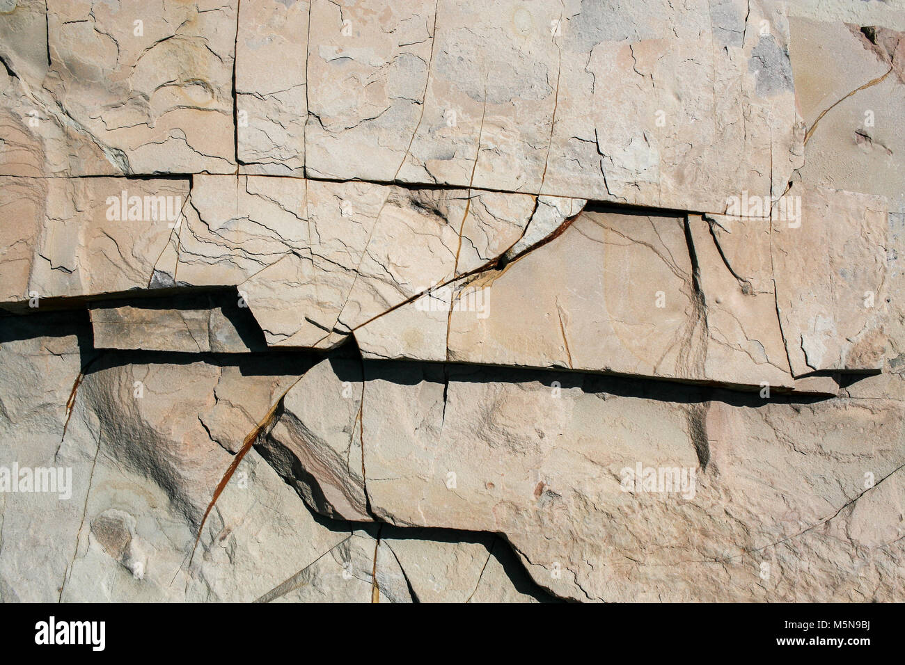 Close-up part of uneven layered stone wall Stock Photo - Alamy