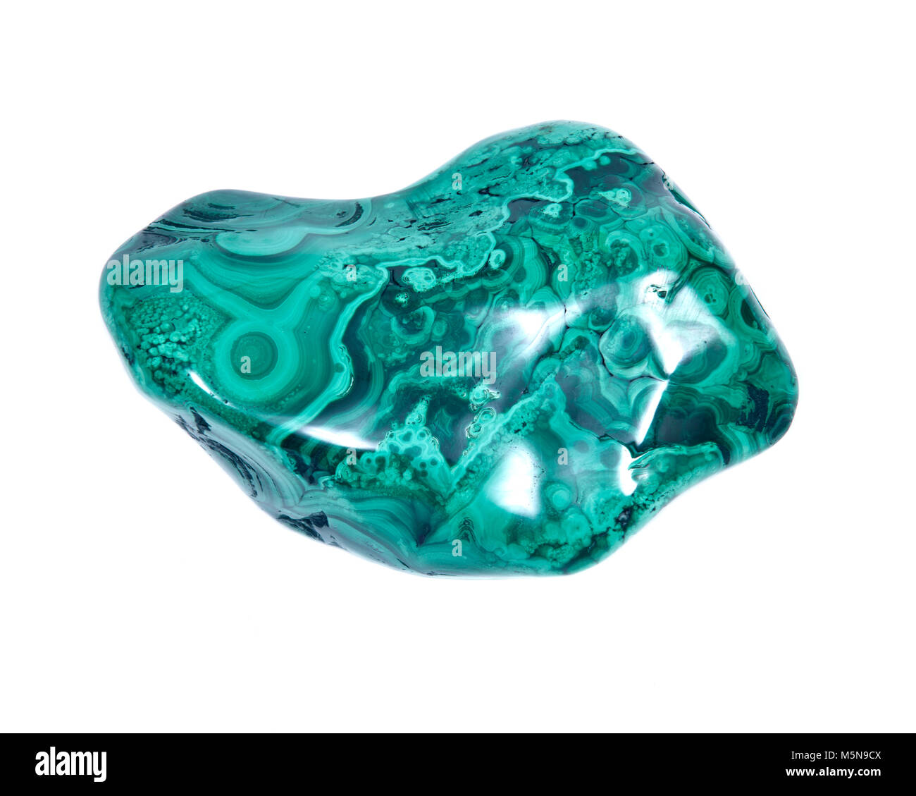 Polished green malachite stone, close up isolated on white background ...