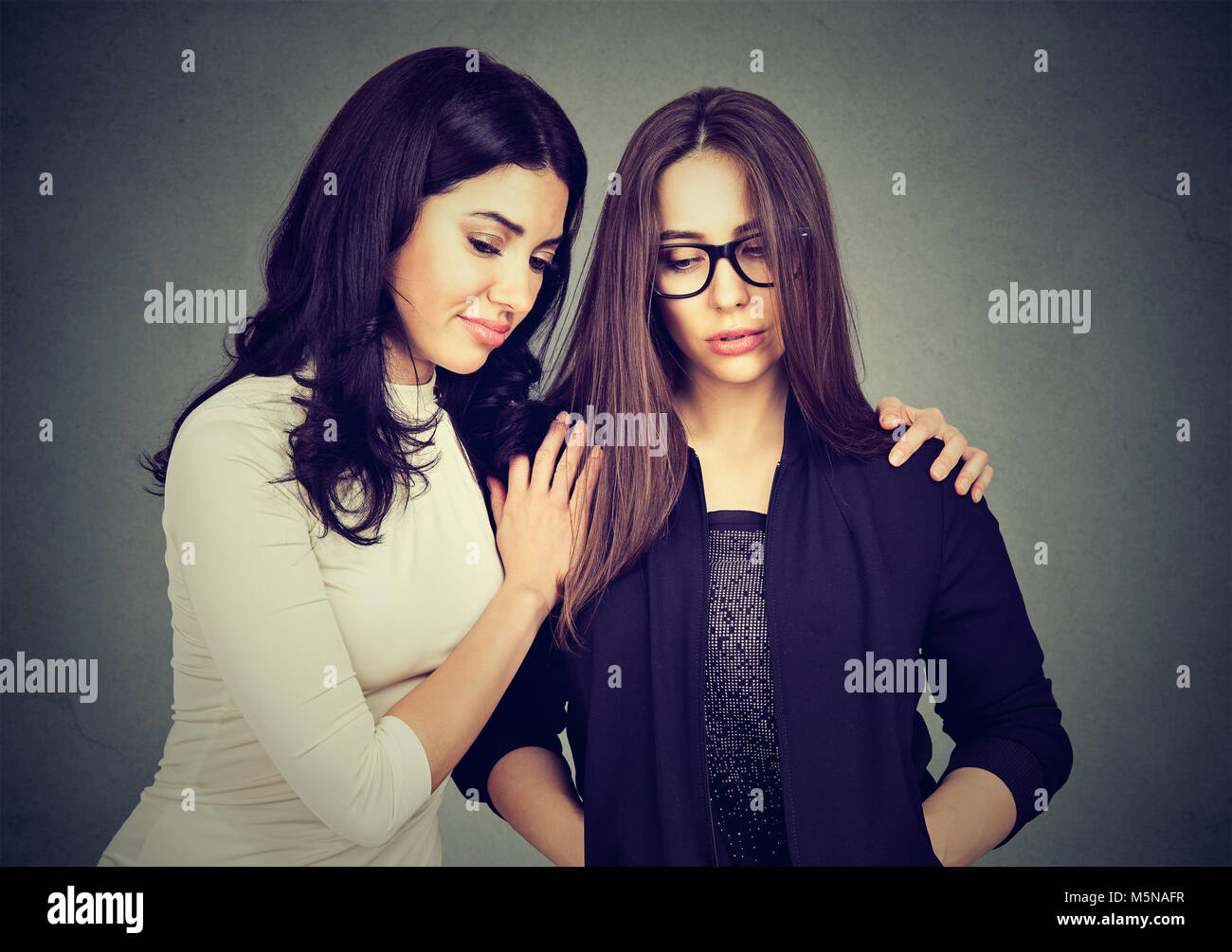 Woman consoling young sad friend helping to cope with problems Stock ...