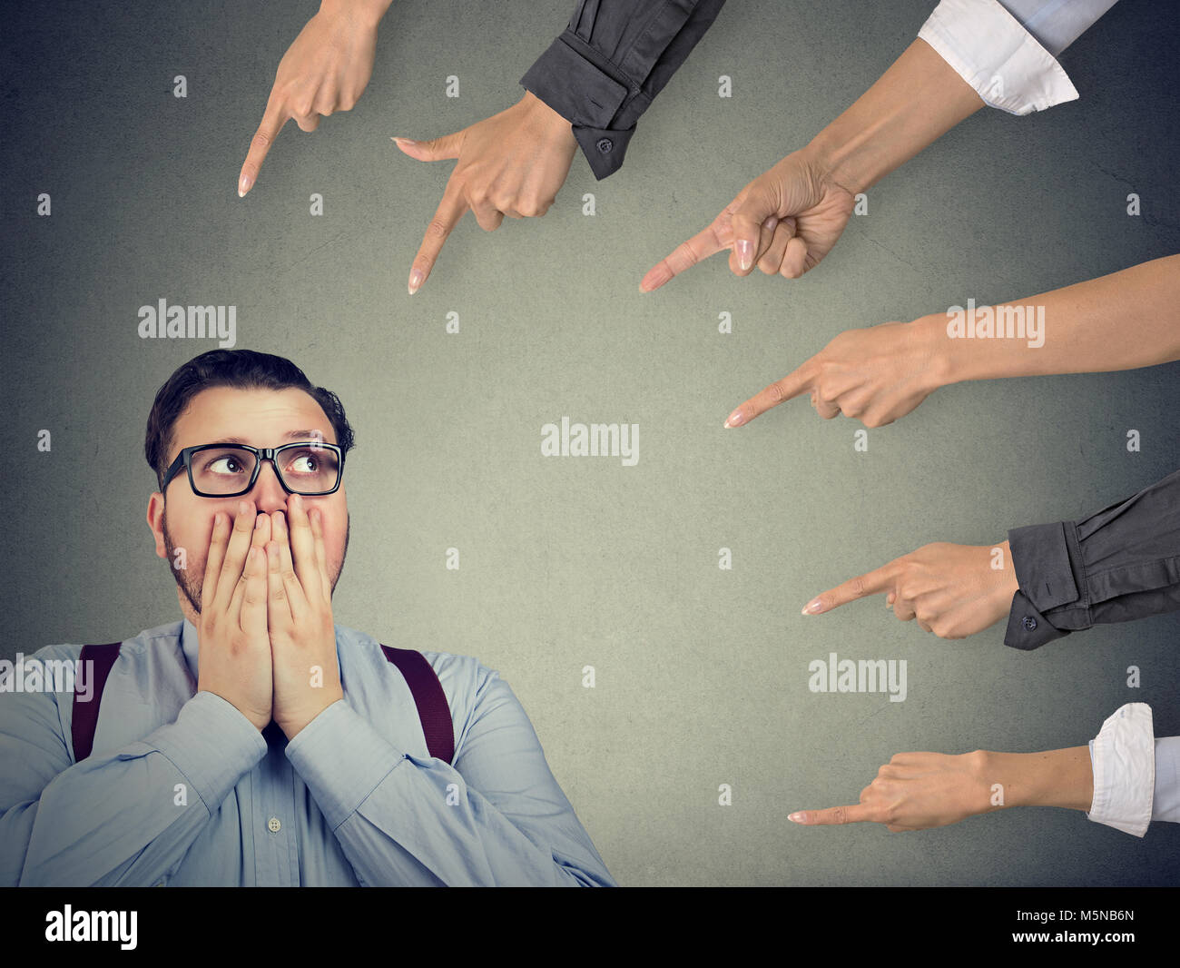 Anxious man judged by different people. Concept of accusation of guilty ...