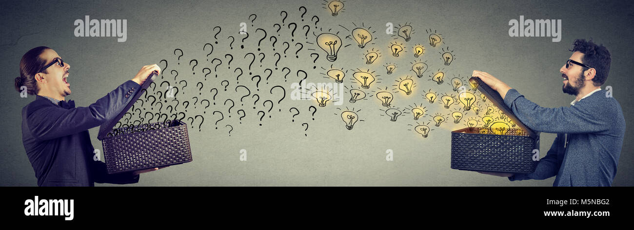 Side view of two young men communicating and helping each other to ...