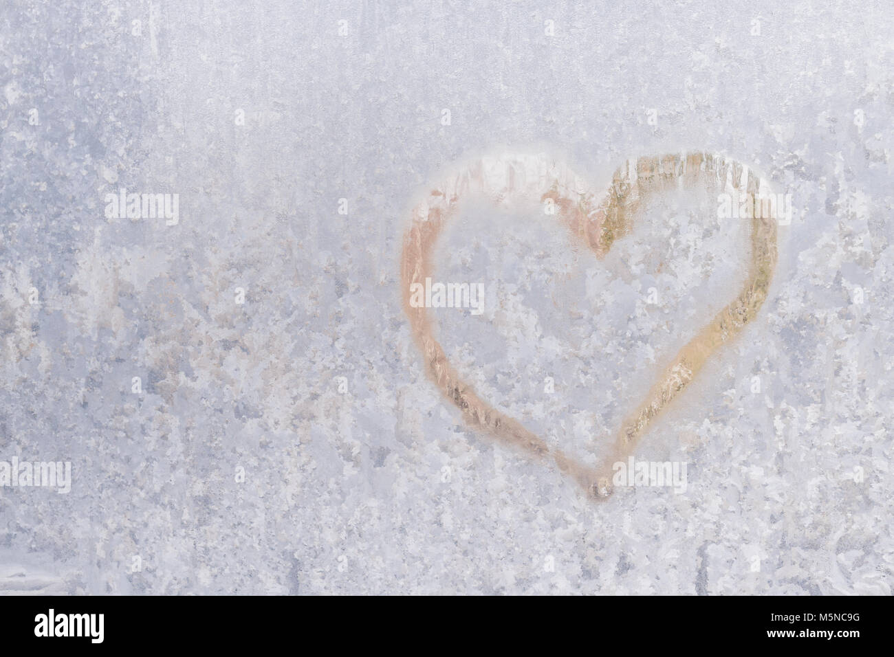 Heart on a frosty winter in the frozen patterns of ice window Stock ...