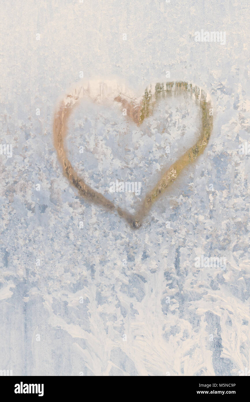 Heart on a frosty winter in the frozen patterns of ice window Stock ...