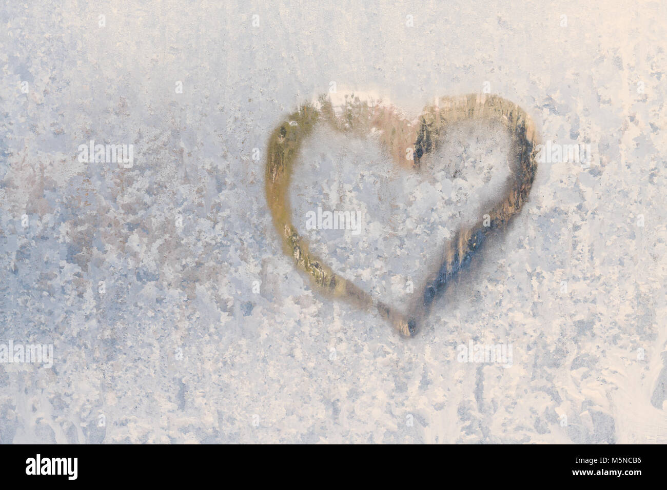 Heart on a frosty winter in the frozen patterns of ice window Stock ...