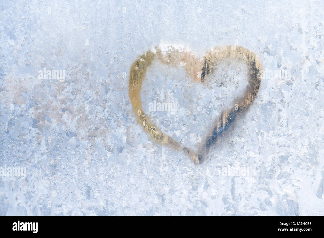 Heart on a frosty winter in the frozen patterns of ice window Stock ...