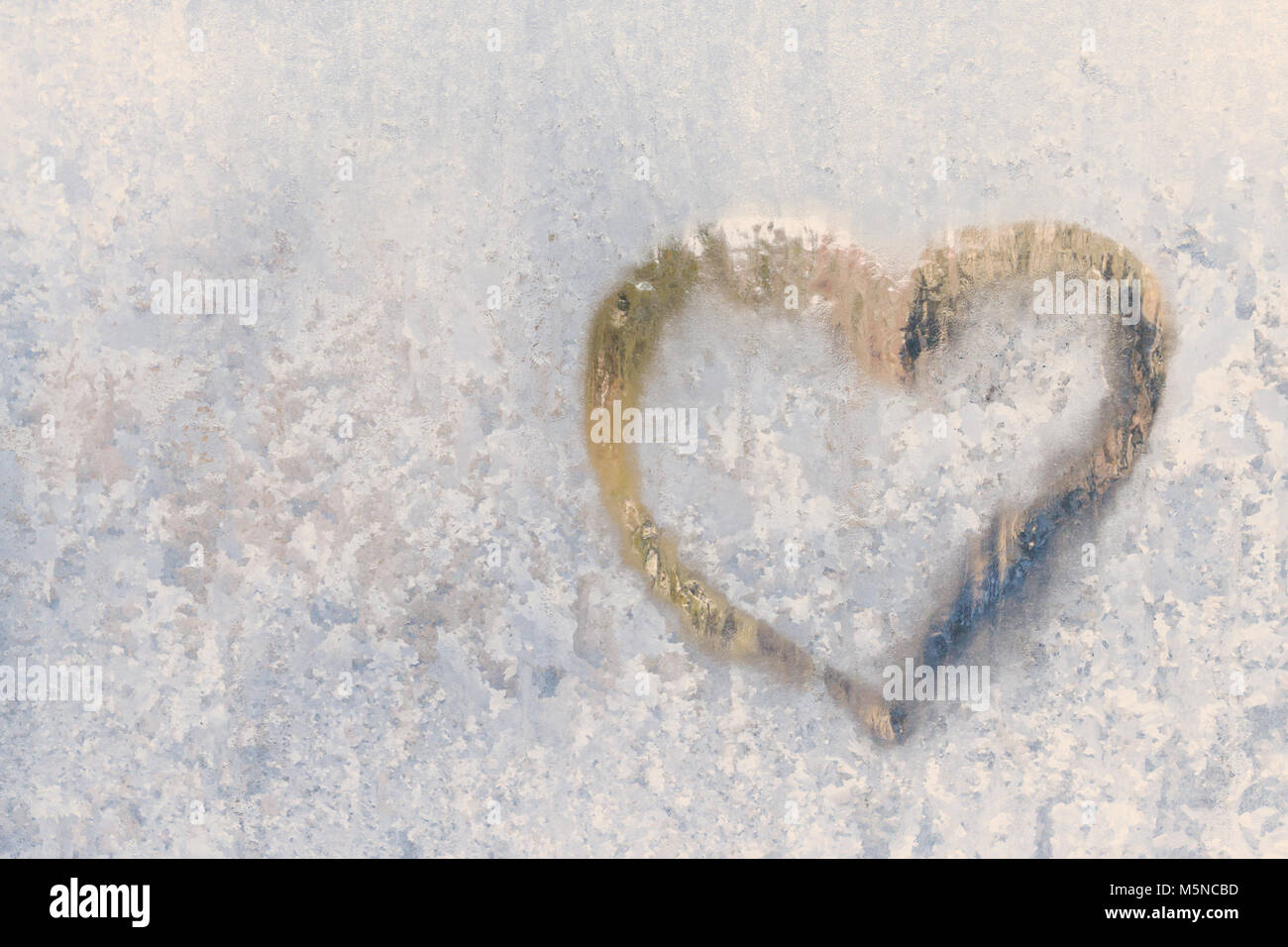 Heart on a frosty winter in the frozen patterns of ice window Stock ...