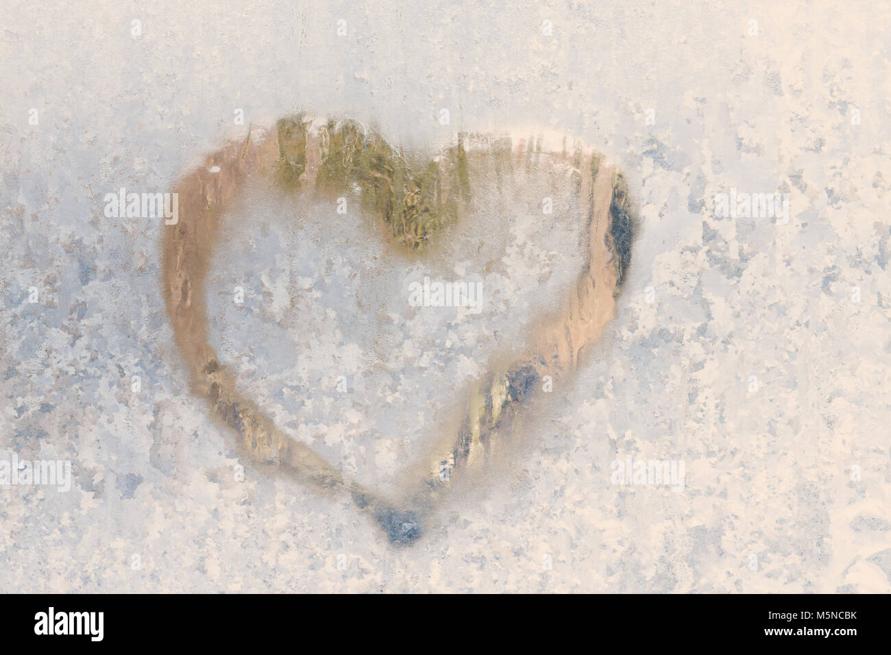 Heart on a frosty winter in the frozen patterns of ice window Stock ...