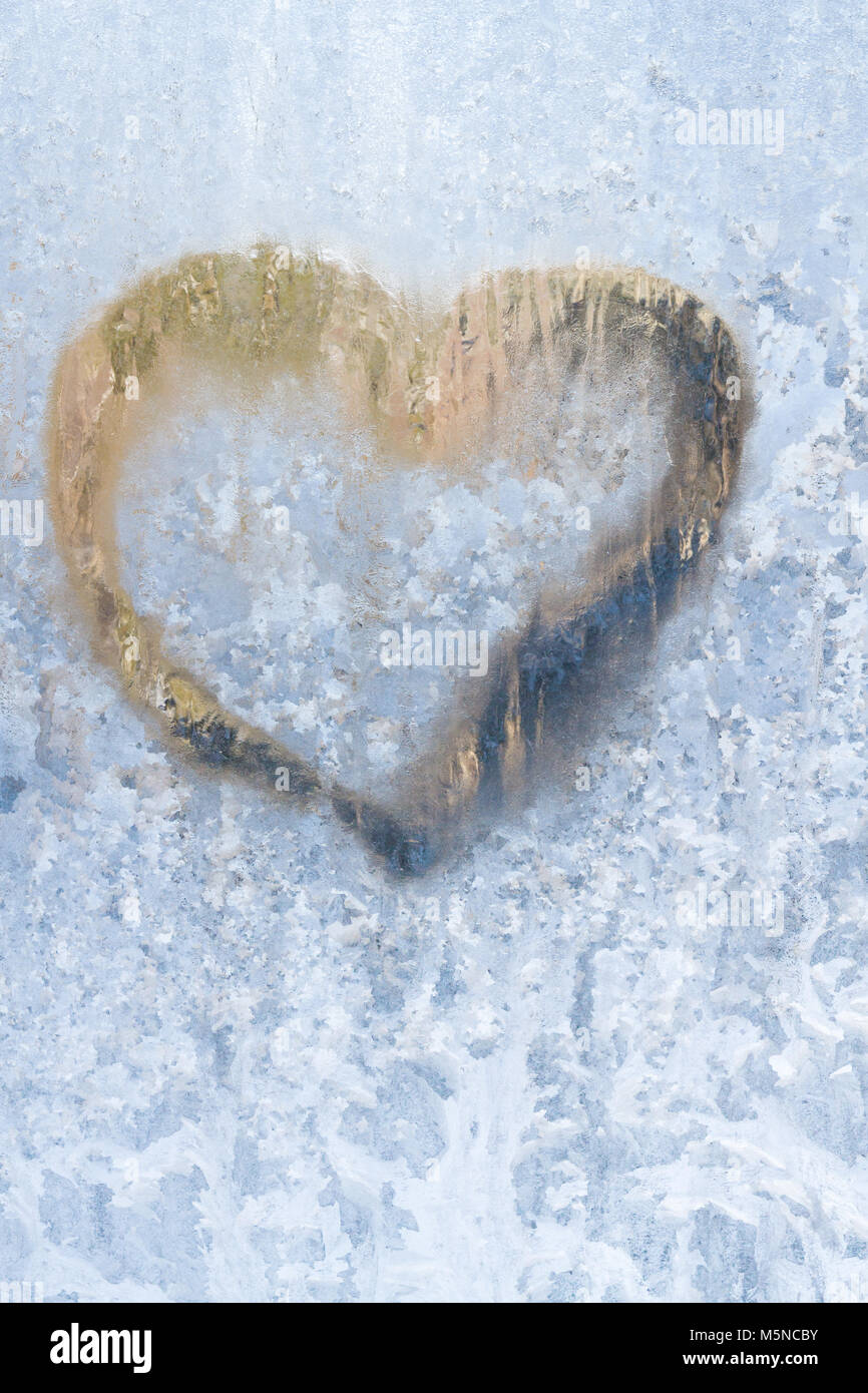 Heart on a frosty winter in the frozen patterns of ice window Stock ...