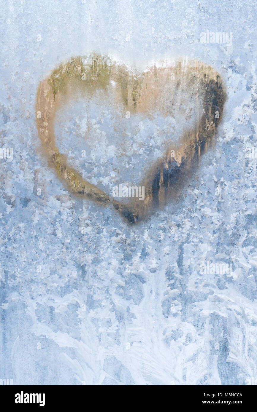 Heart on a frosty winter in the frozen patterns of ice window Stock ...