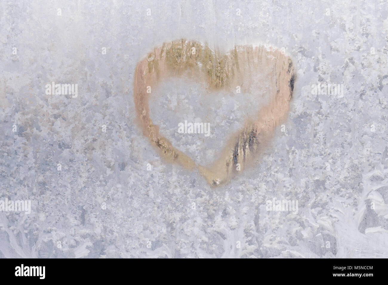 Heart on a frosty winter in the frozen patterns of ice window Stock ...