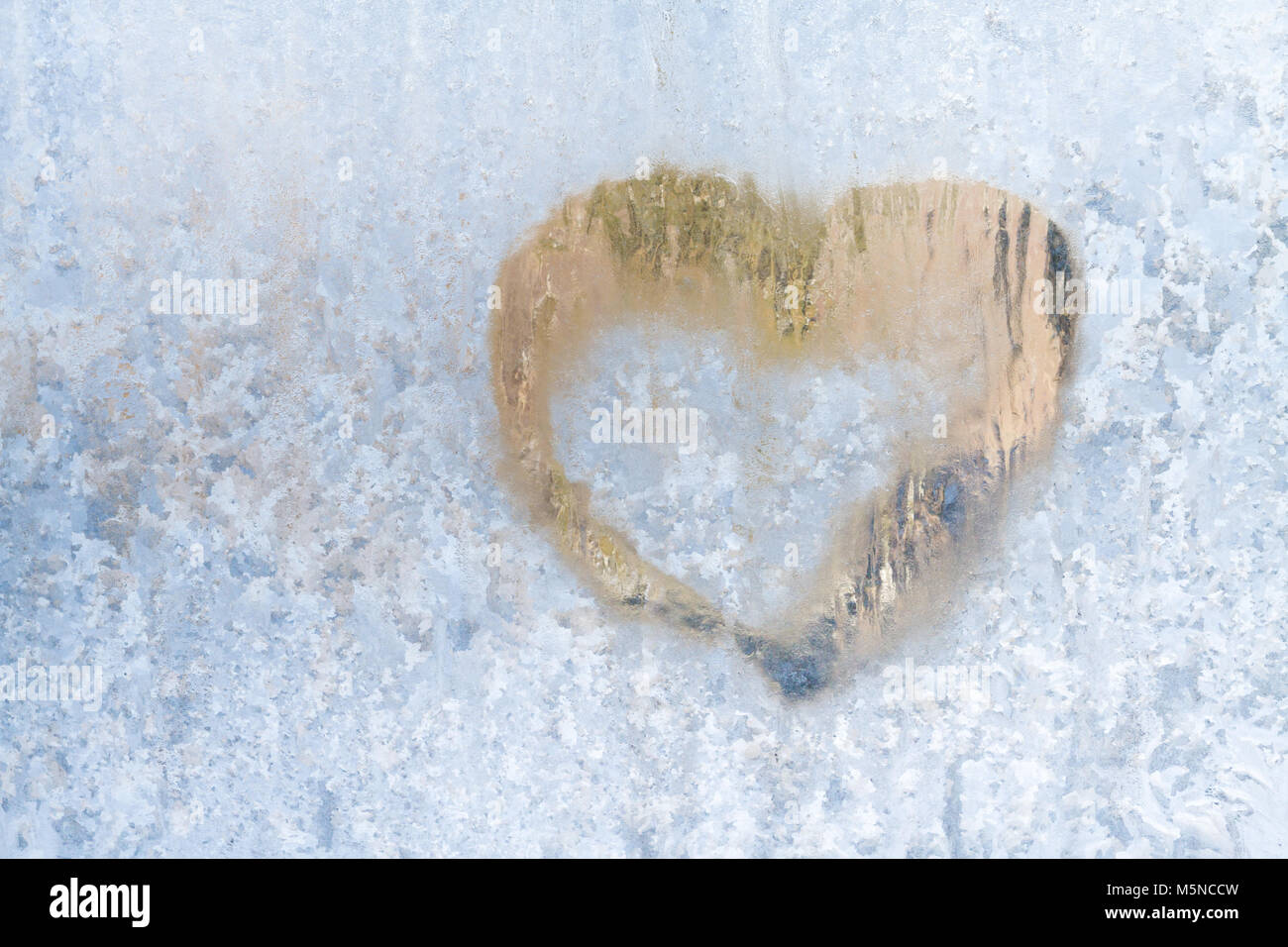 Heart on a frosty winter in the frozen patterns of ice window Stock ...