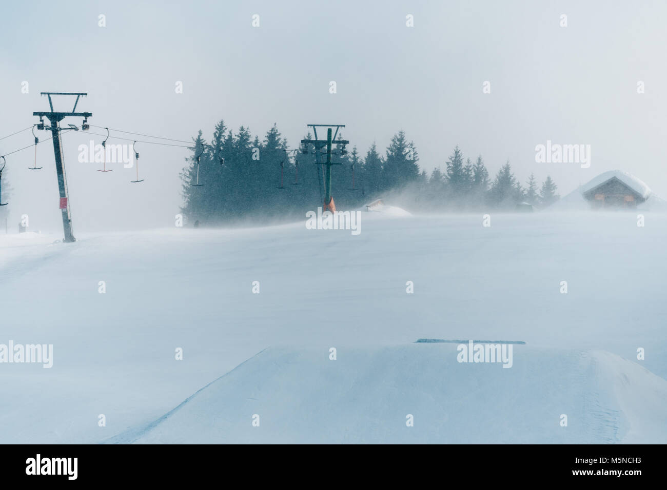 Strong wind on the top of ski slope in winter. A lot of snow. Surface ...