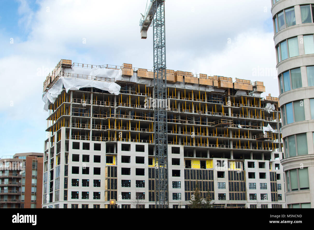 Construction of the modern condo buildings with huge windows and ...