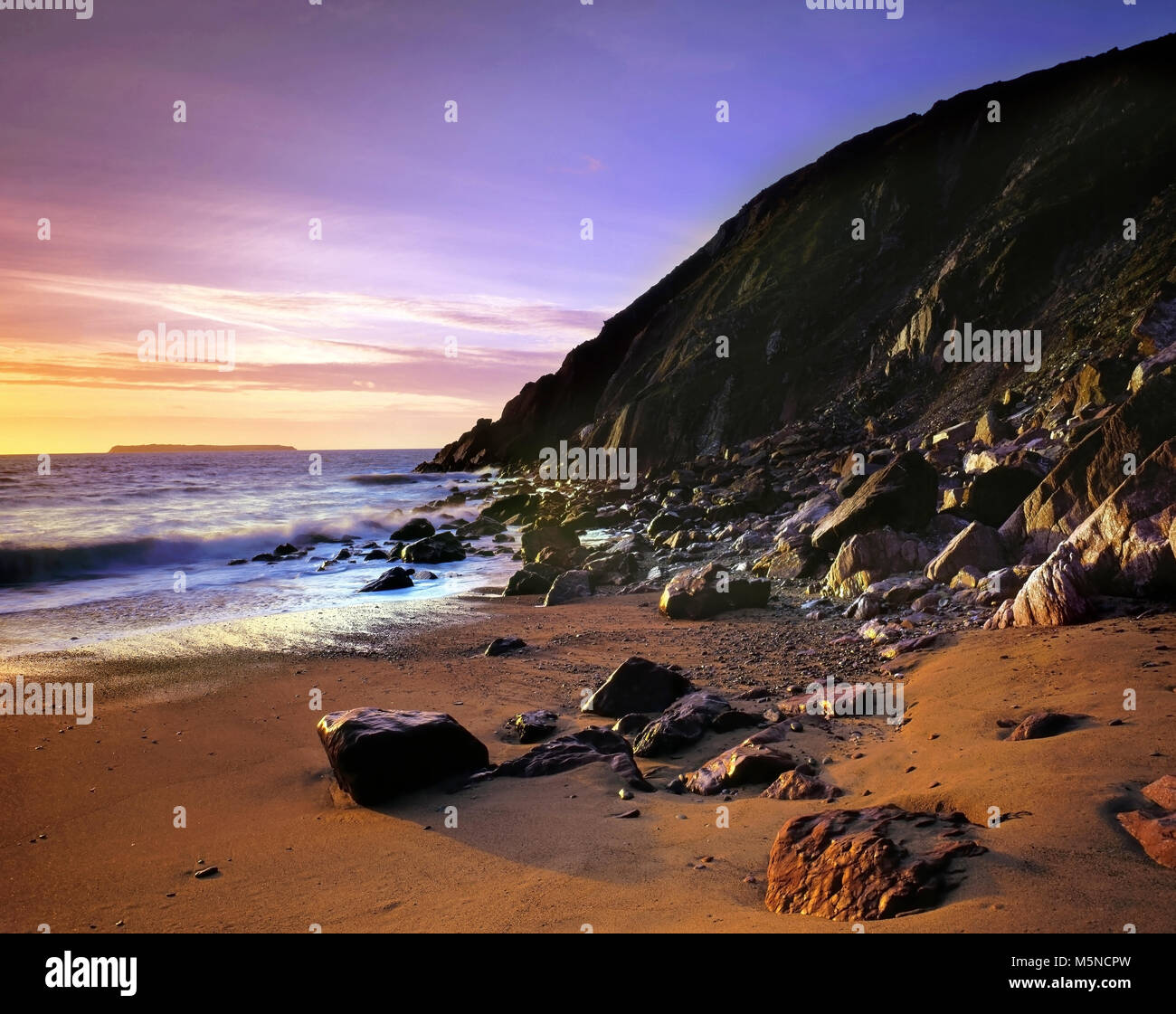 Looking across West Angle Bay, Pembrokeshire as the sun sets Stock ...