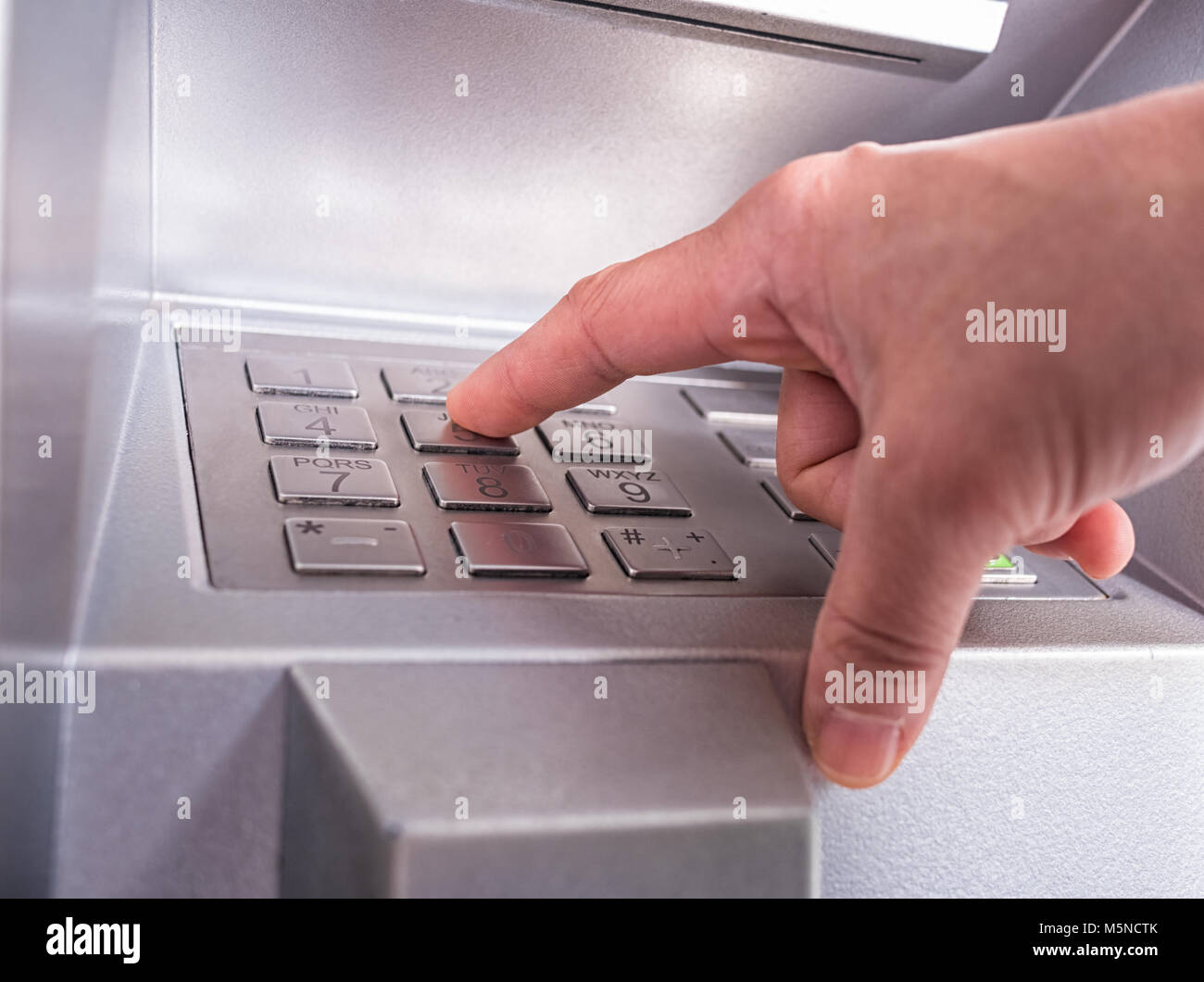 Closeup of hand entering PIN/pass code on bank machine keypad Stock ...