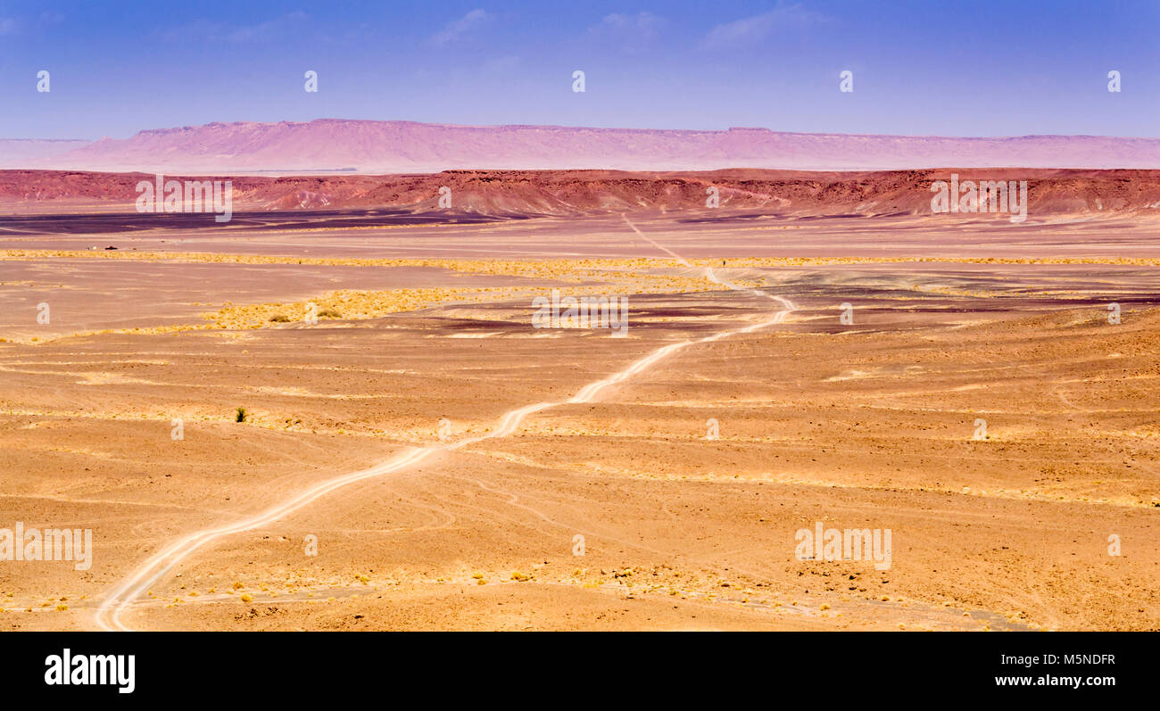 Sahara desert view with mountains and road crossing Stock Photo - Alamy