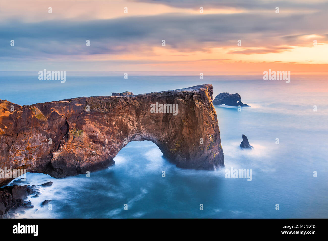 Dyrholaey rock formation at sunset. Dyrholaey is a promontory located ...