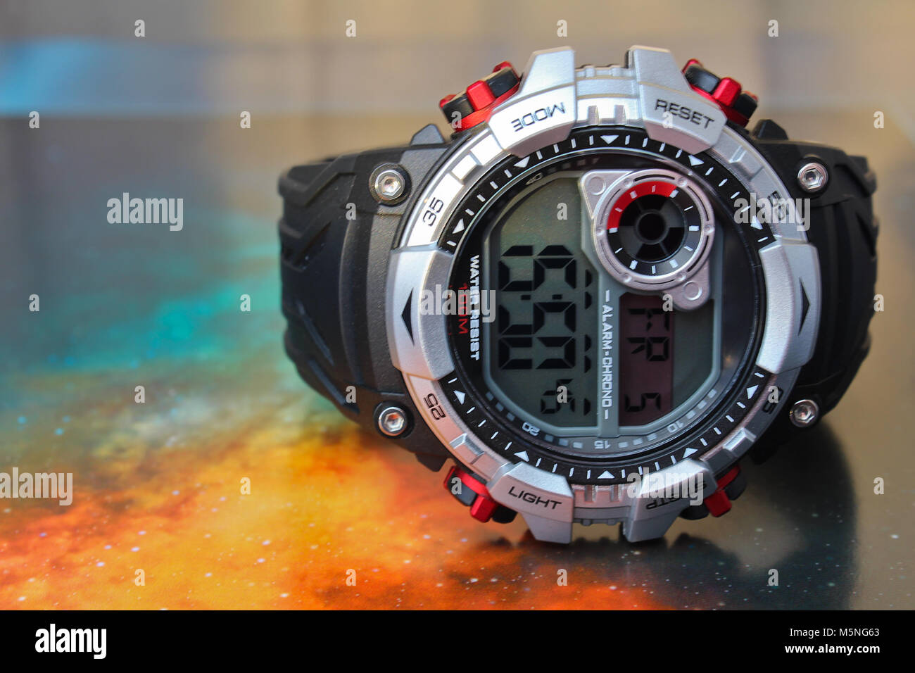 Men digital sport hand watch on orange and cyan background Stock Photo ...