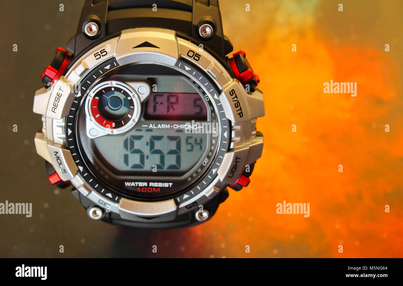 Men digital sport hand watch on orange background Stock Photo - Alamy