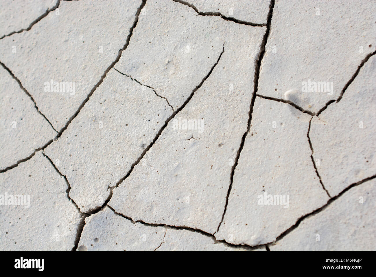 Grey color dry cracked muddy earth as a background texture Stock Photo ...