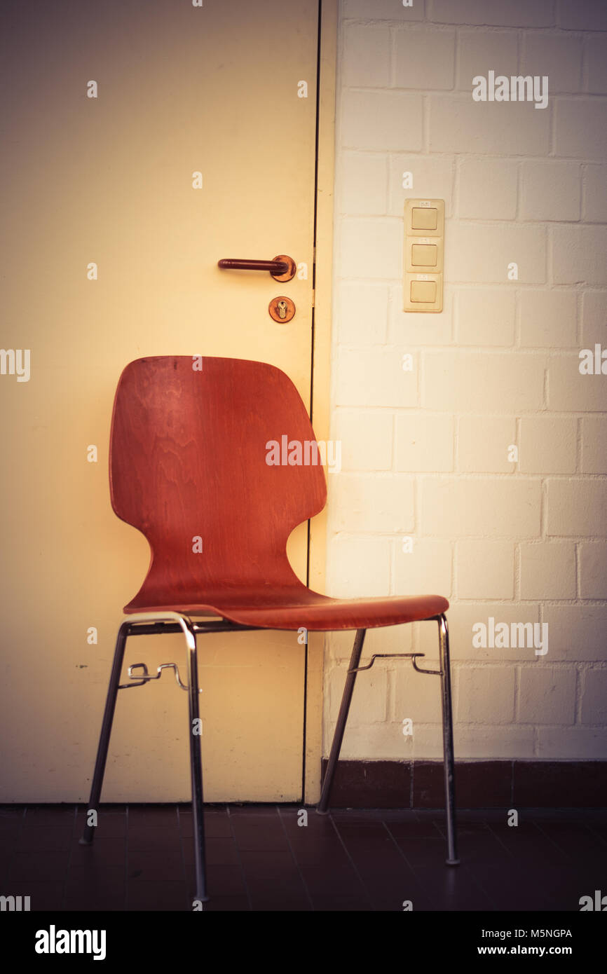 red chair in front of a door Stock Photo - Alamy