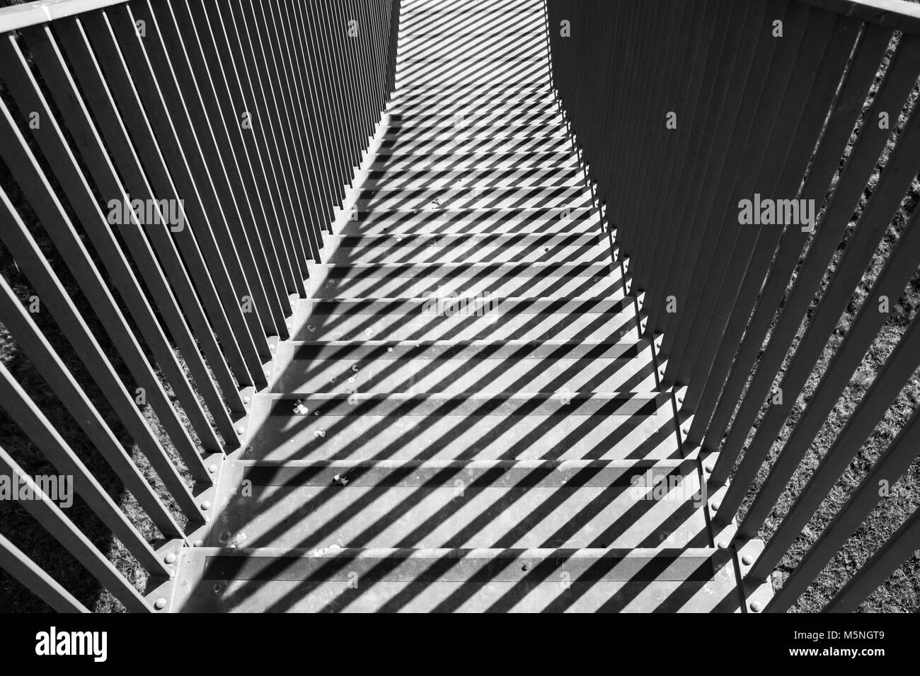 Geometric shadows - lines and parallel stripes on stairs. Sun and ...