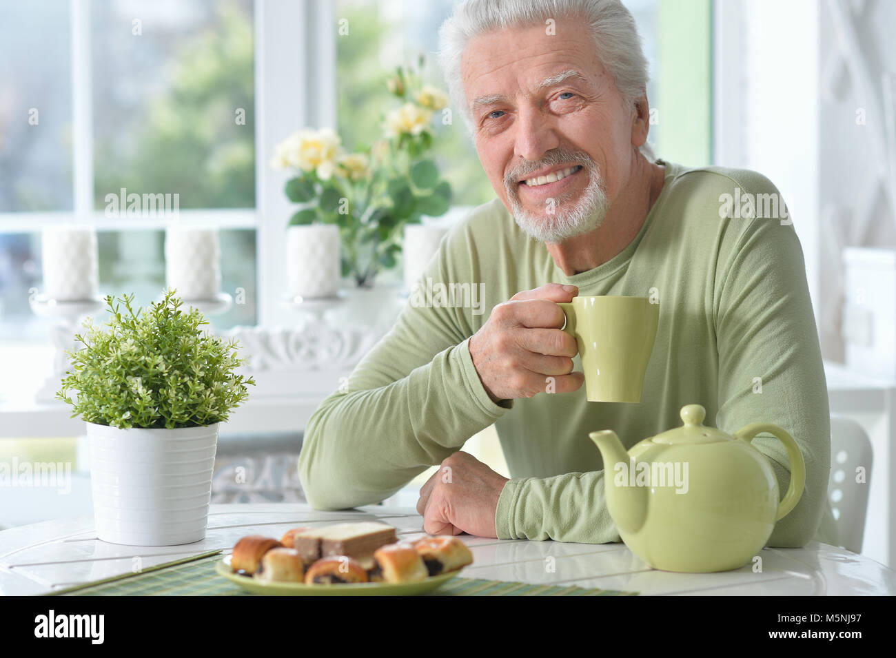 Senior man drinking tea Stock Photo - Alamy