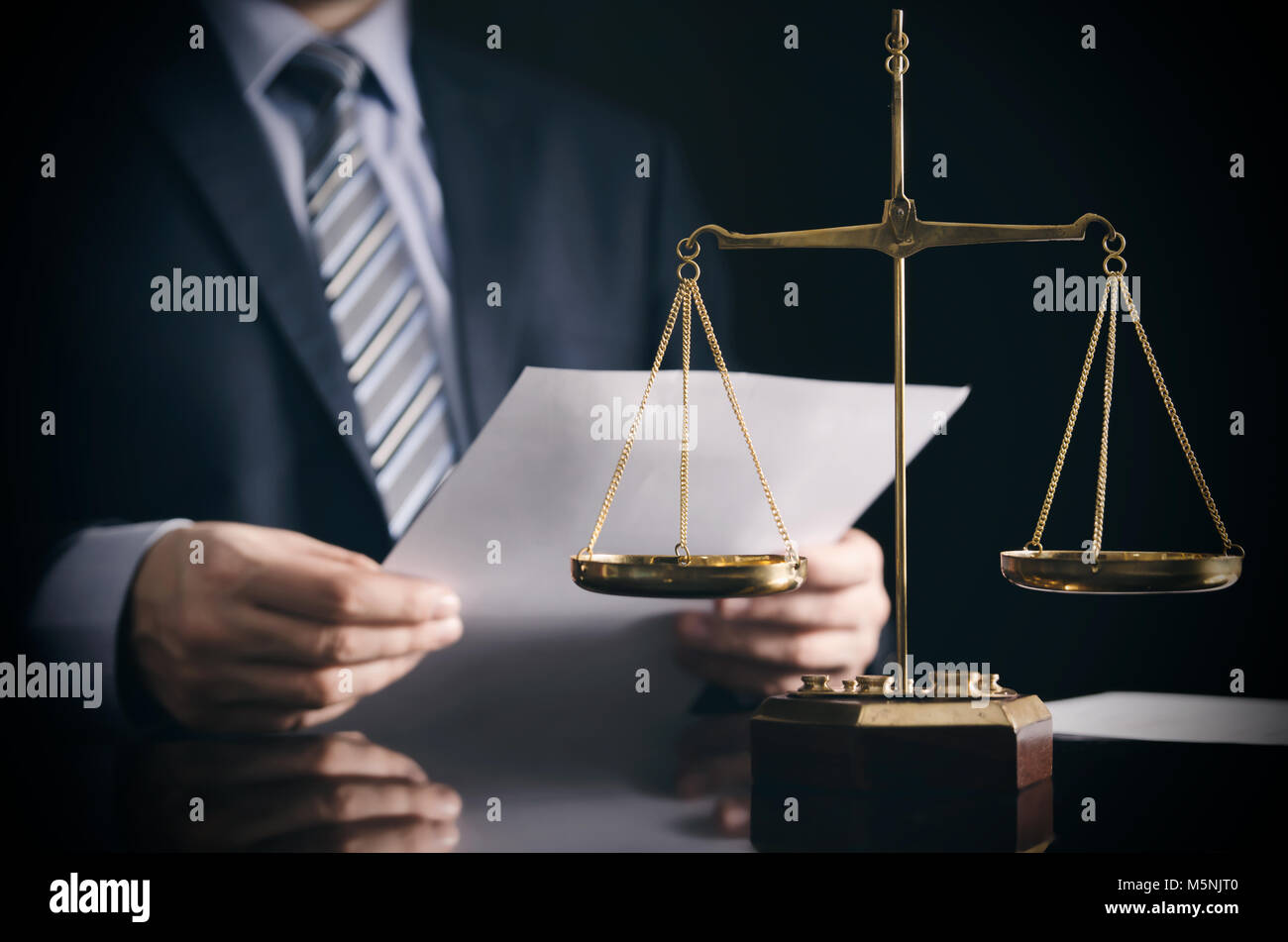 Lawyer or attorney works in his office. Scales on the desk Stock Photo ...