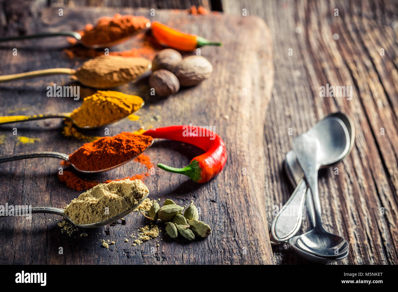 Various condiments on old table Stock Photo - Alamy