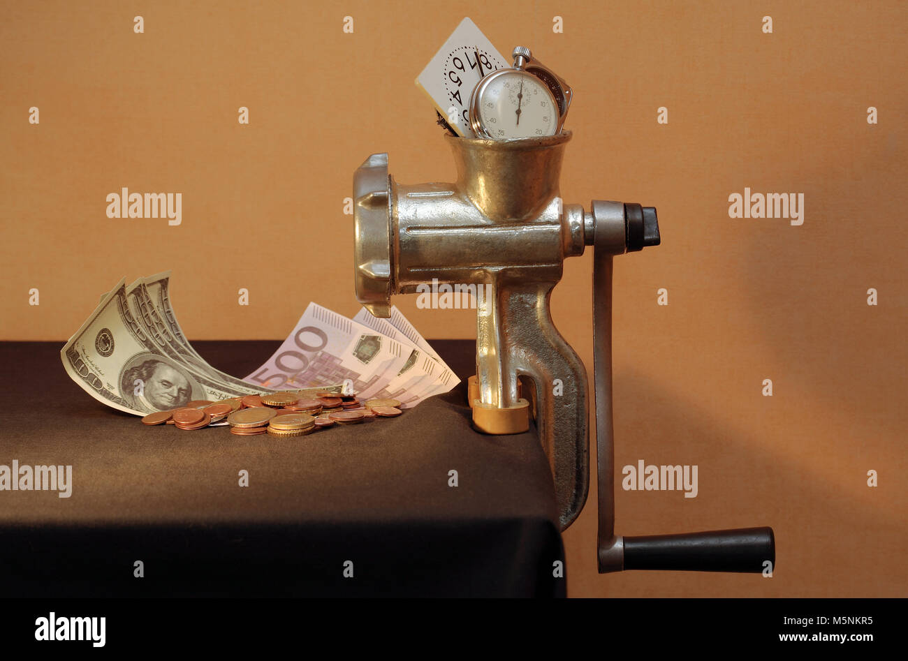 Conceptual still life with mincing machine, money and clock (horizontal ...
