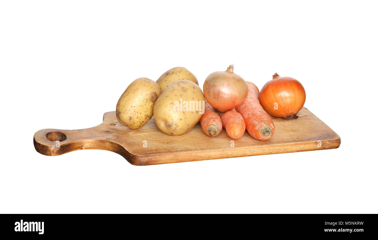 Few raw vegetables lying on wooden hardboard. Isolated on white with ...