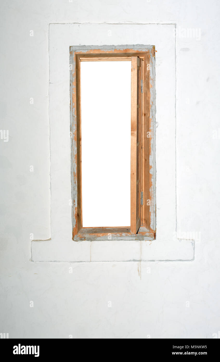 Open narrow high wooden window on white wall. Isolated with clipping ...